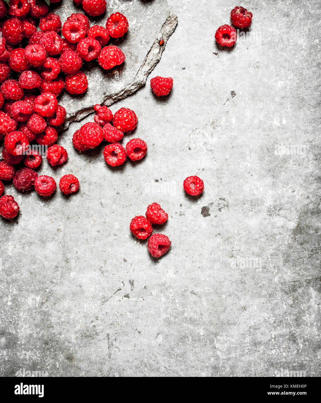 Fresh raspberry on table . On a stone background Stock Photo - Alamy