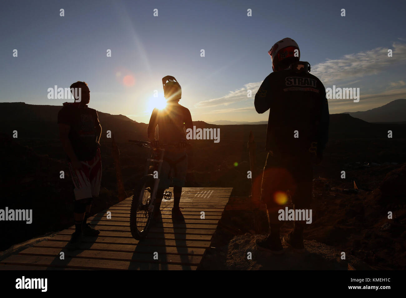 Three Mountain Bikers at Red Bull Rampage standing at sunset,Utah,USA ...