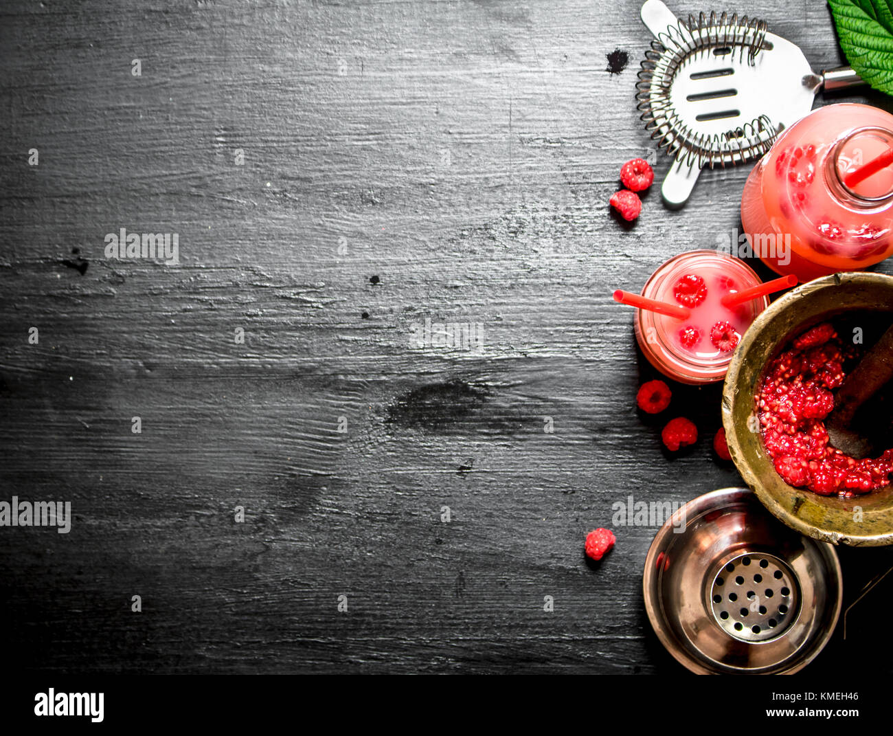Cooking raspberry juice. On a black wooden background Stock Photo - Alamy