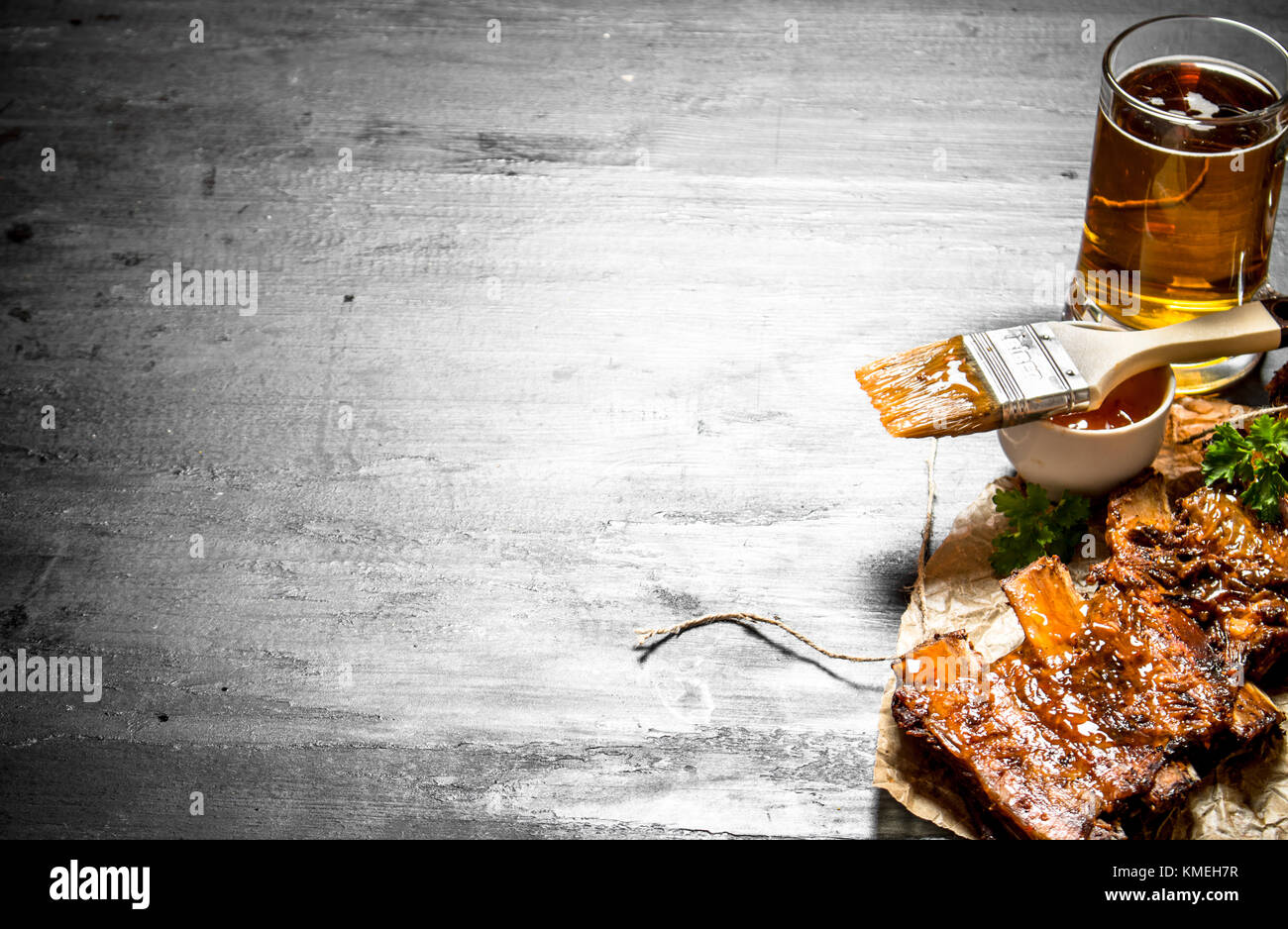 Barbecue pork ribs with beer and sauce. On the black chalk Board Stock ...