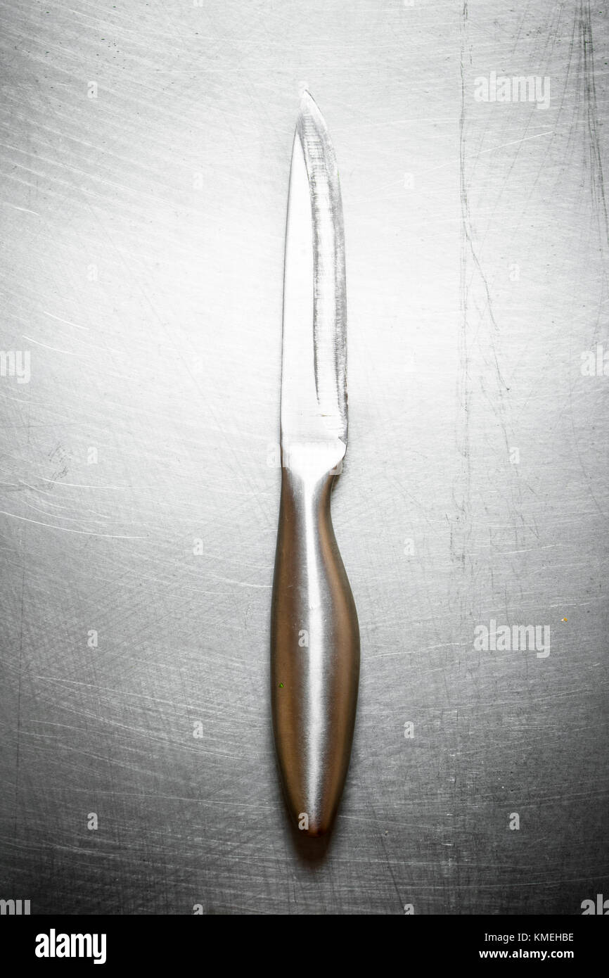 Metal steel knife . On the metal table Stock Photo - Alamy