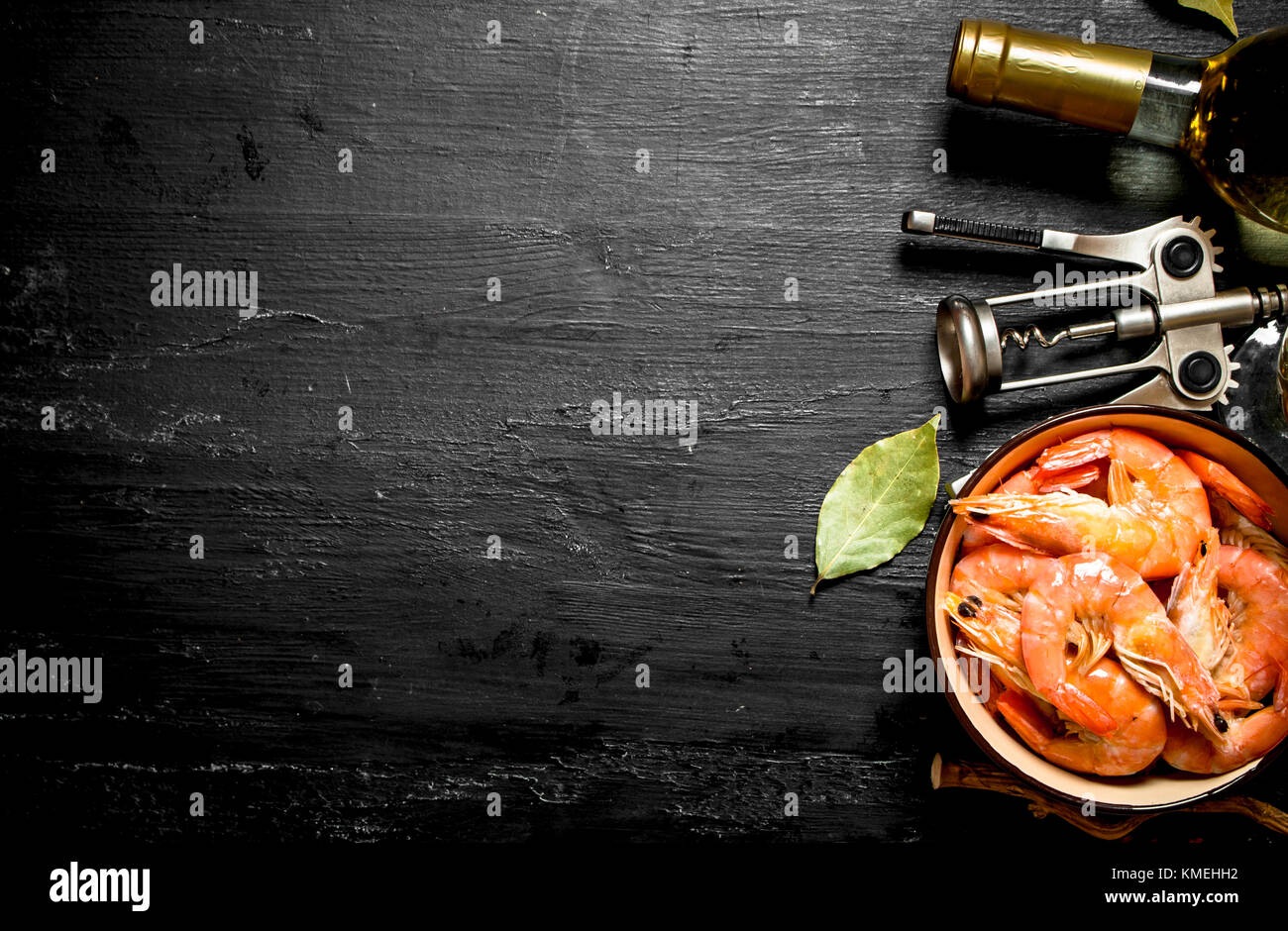 Shrimp with white wine and a corkscrew. On the black chalkboard Stock ...