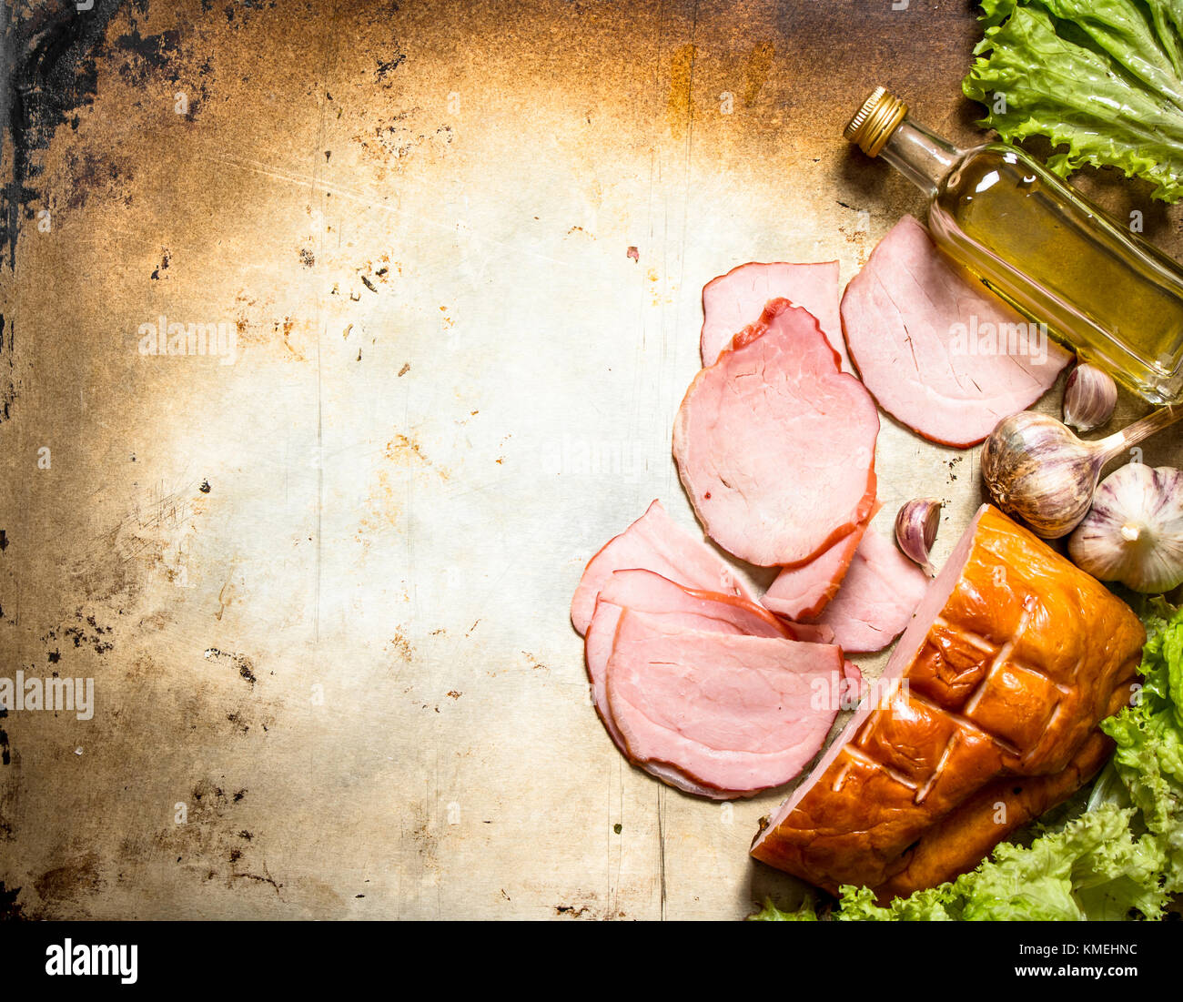 Slices of ham with garlic and herbs . On an old rustic background Stock ...