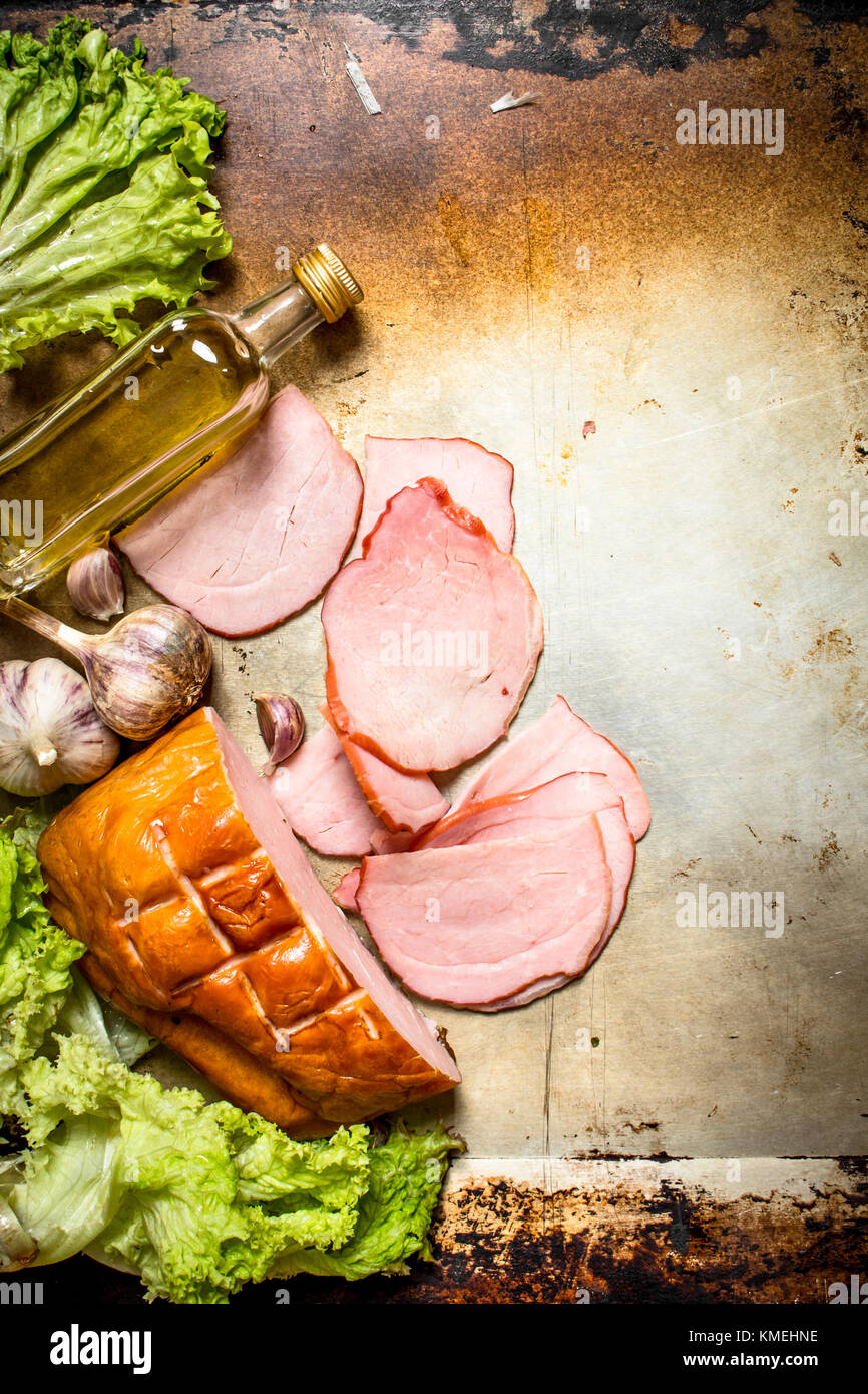 Slices of ham with garlic and herbs . On an old rustic background Stock ...