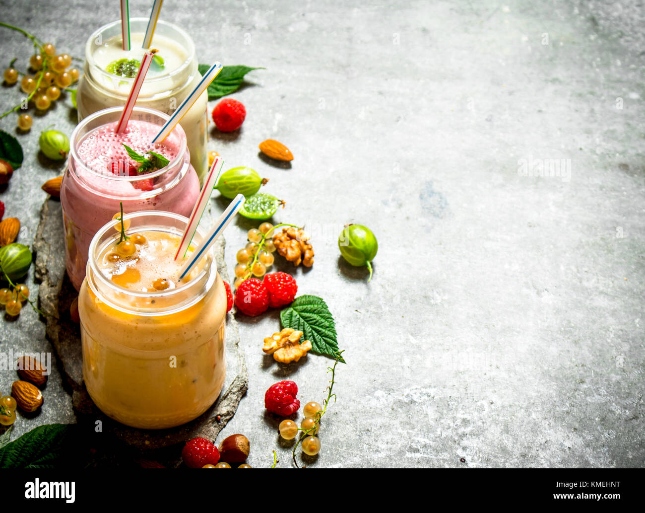 Berry smoothies with nuts. On a stone background Stock Photo - Alamy