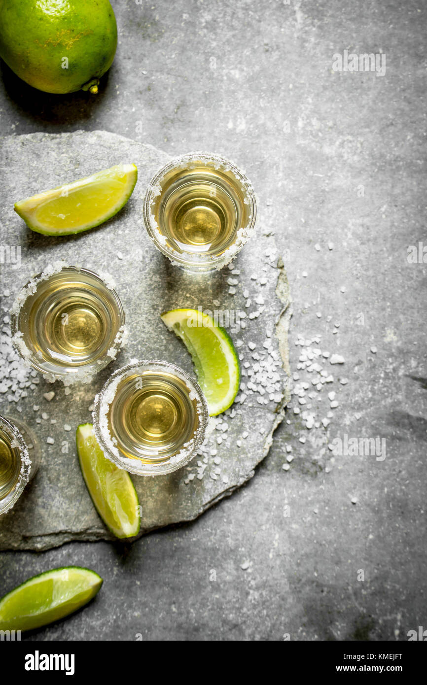 Tequila shots with lime and salt . On the stone table Stock Photo - Alamy
