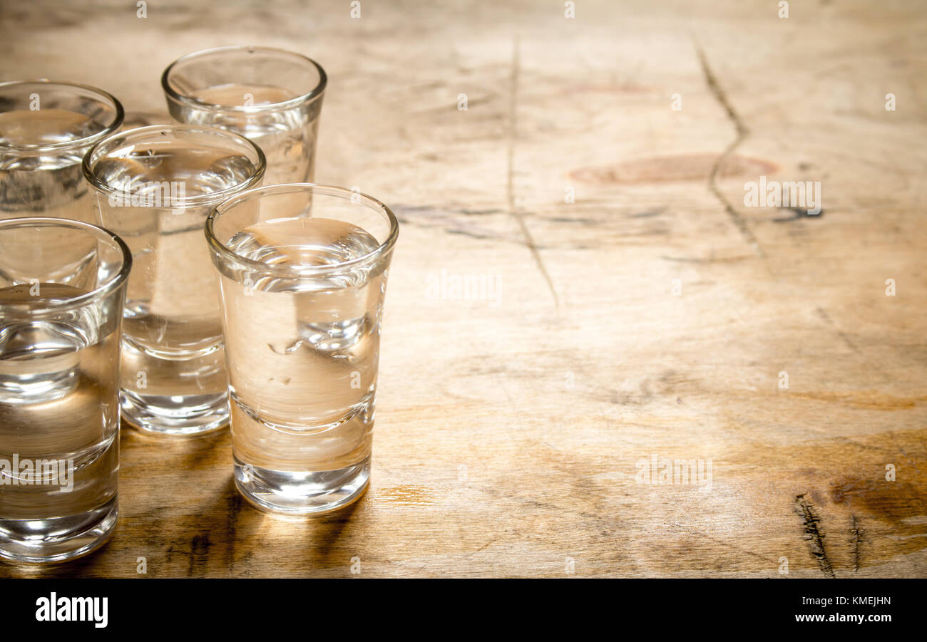 The vodka glass. On a wooden background Stock Photo - Alamy