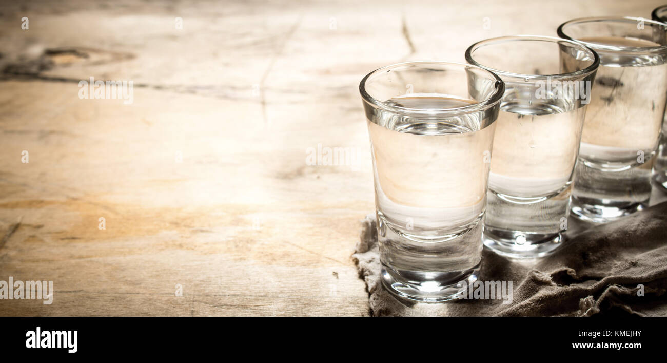 The vodka glass. On a wooden background Stock Photo - Alamy