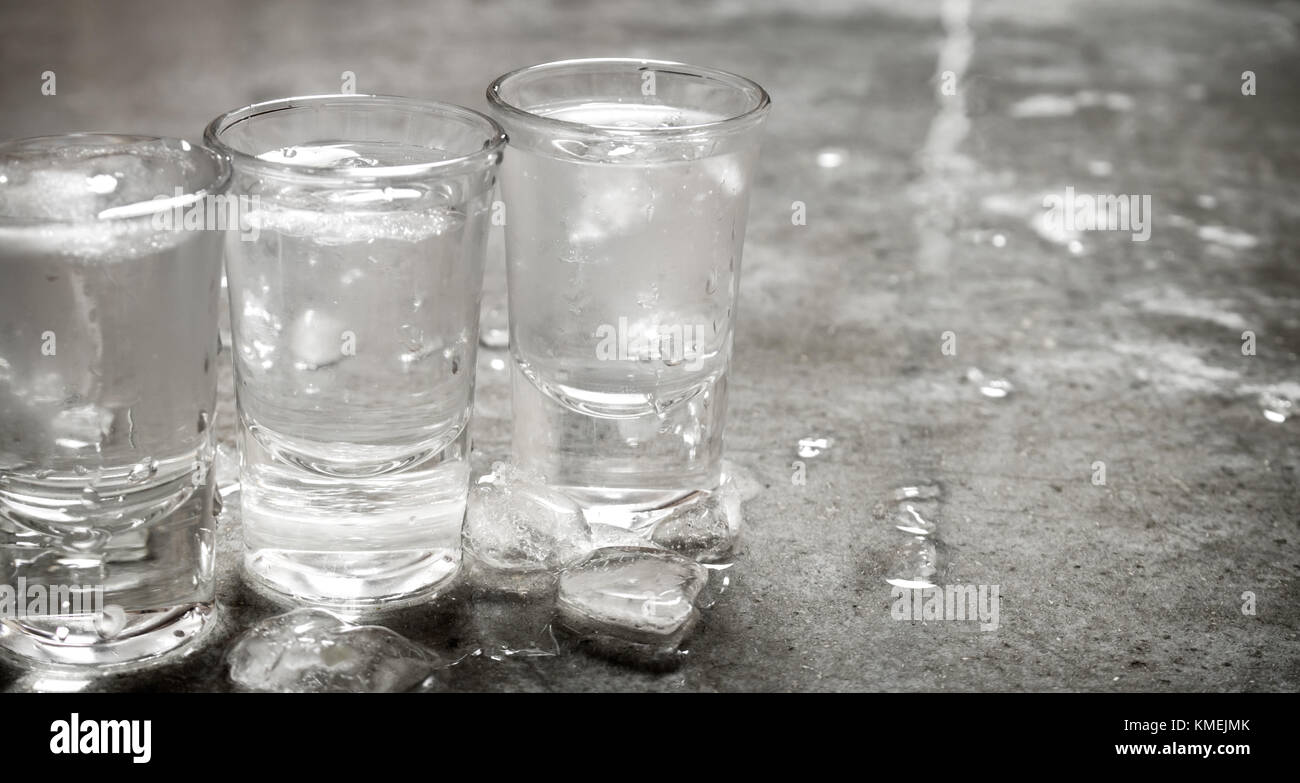 The vodka glass with ice. On the stone table Stock Photo - Alamy