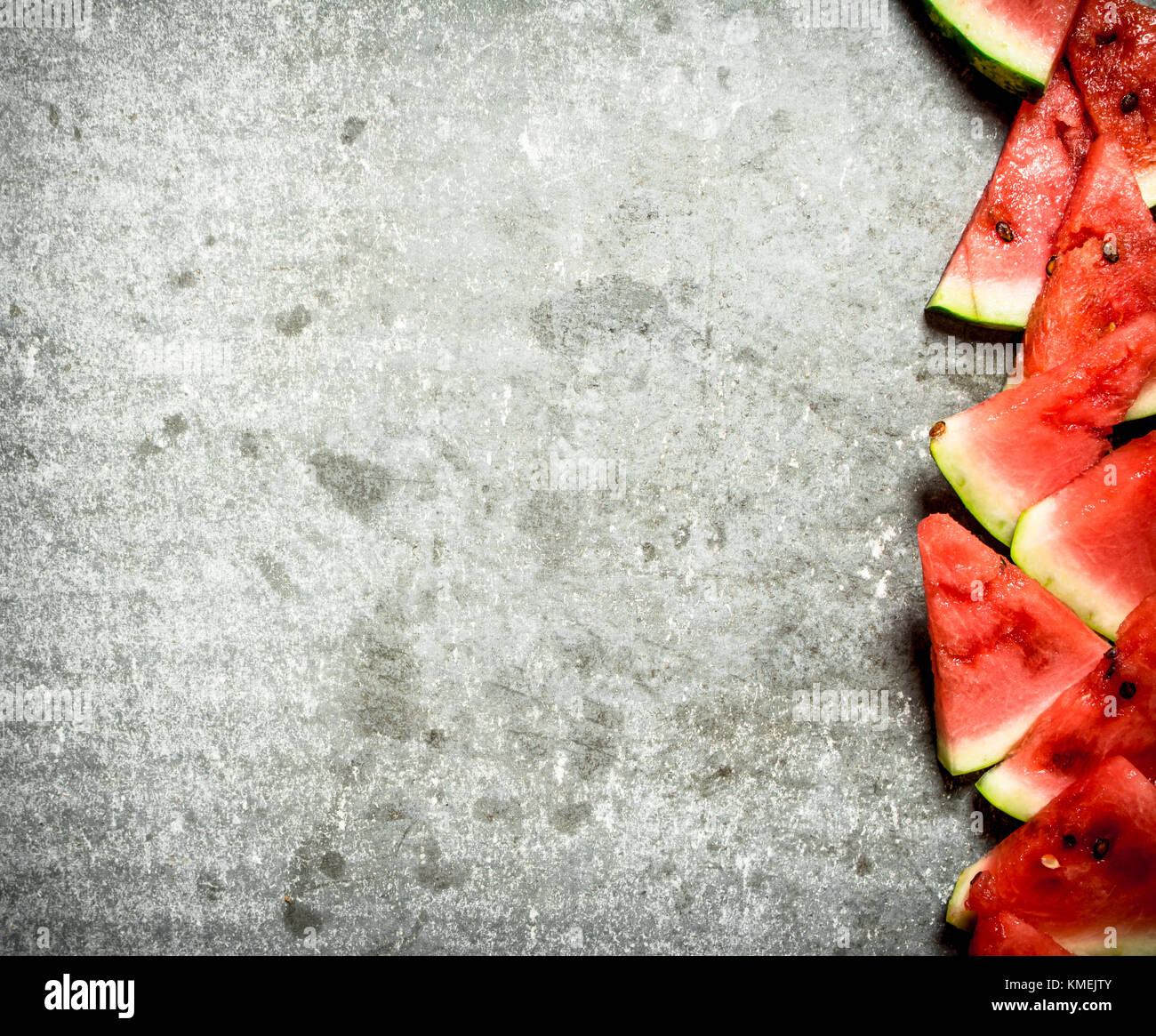 pieces of watermelon. On the stone table Stock Photo - Alamy