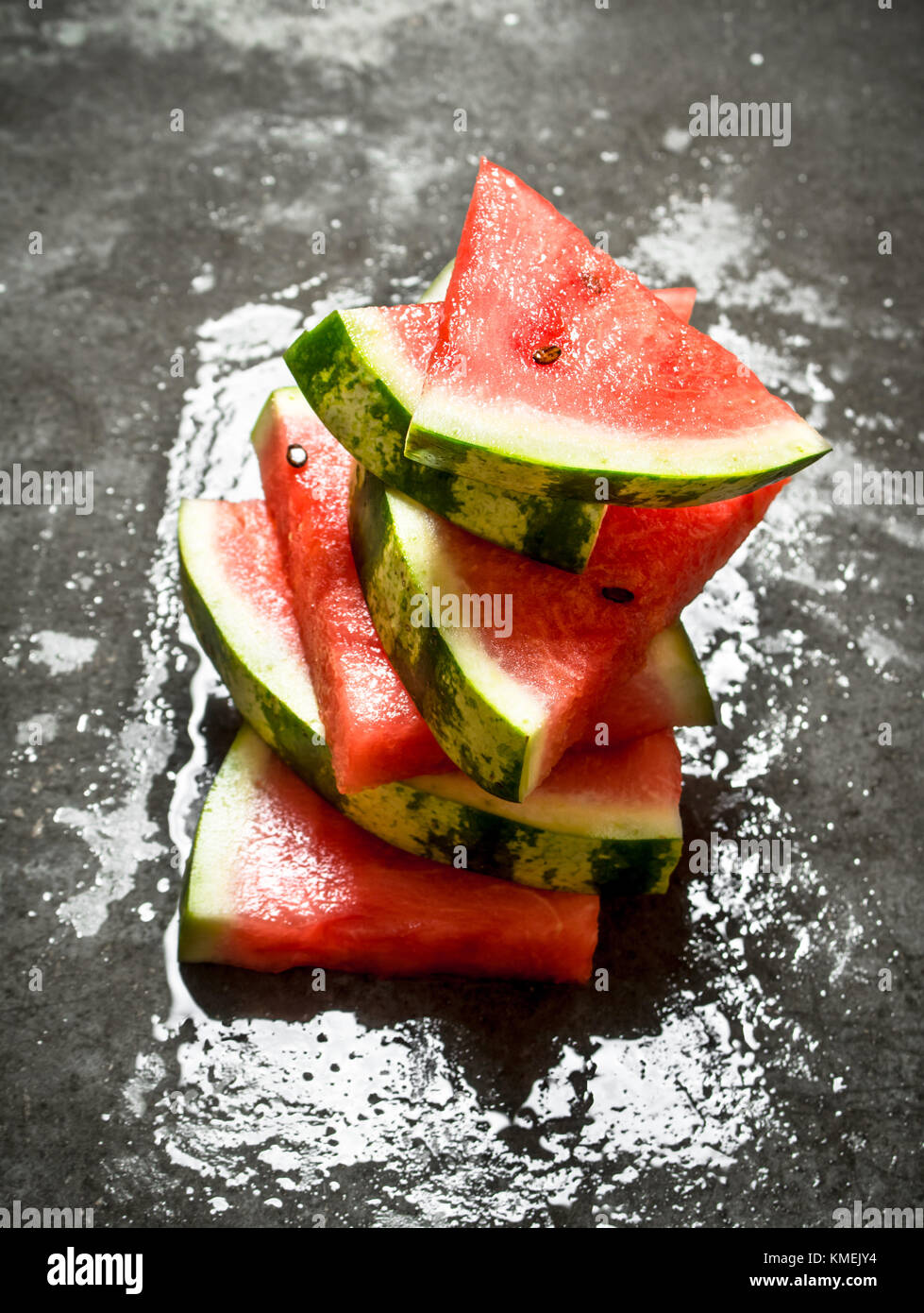 Slices of fresh watermelon. On the stone table Stock Photo - Alamy
