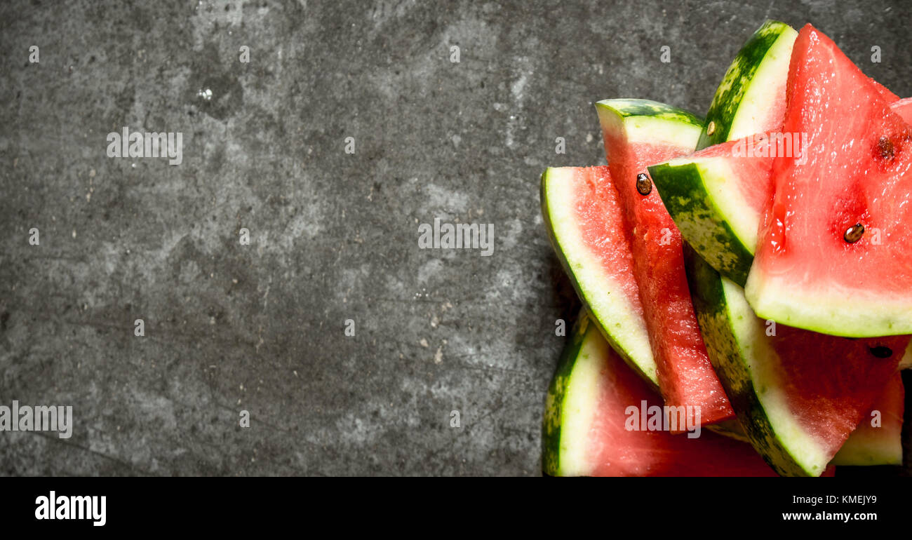 Slices of fresh watermelon. On the stone table Stock Photo - Alamy