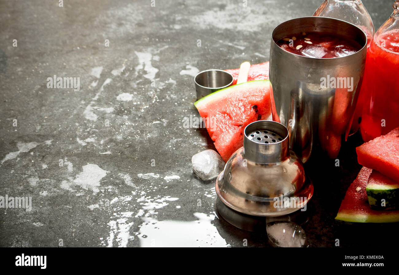 Watermelon cocktail with ice in a shaker. On the stone table Stock ...