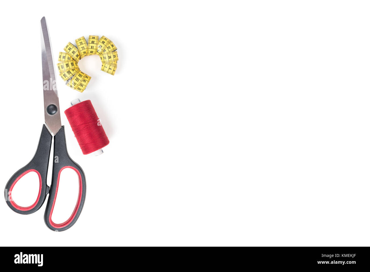 Sewing supplies big scissors with black handle, red sewing thread and ...