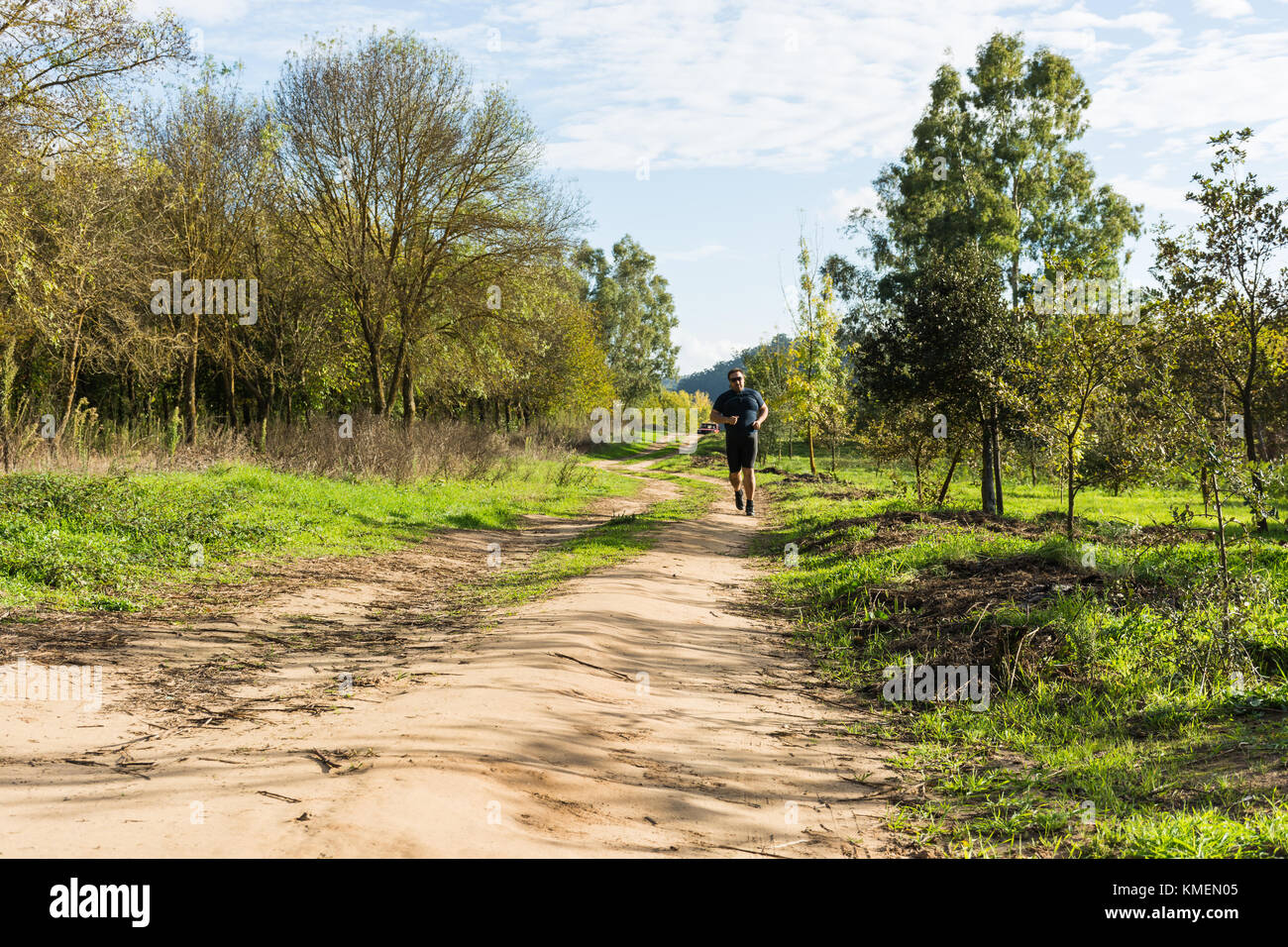 Big belly man jogging , exercising, doing cardio in the park , slightly ...