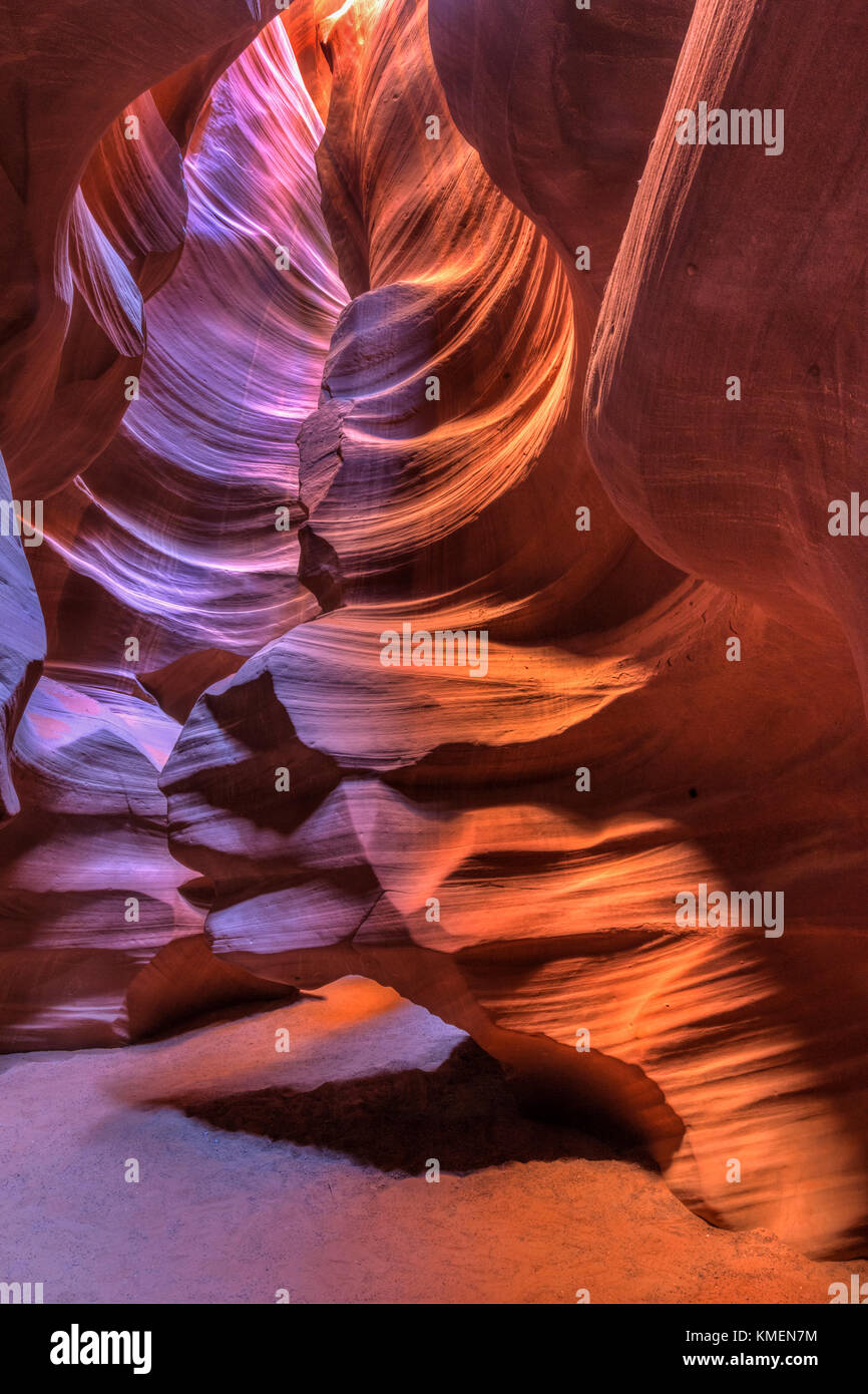 Twisting, striated red sandstone walls of Upper Antelope Canyon lit ...