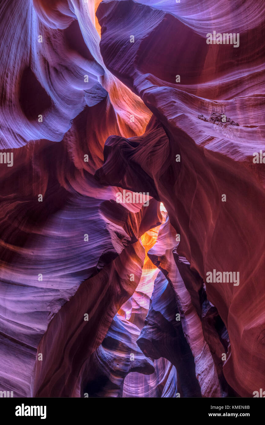 Twisting, striated red sandstone walls of Upper Antelope Canyon lit ...