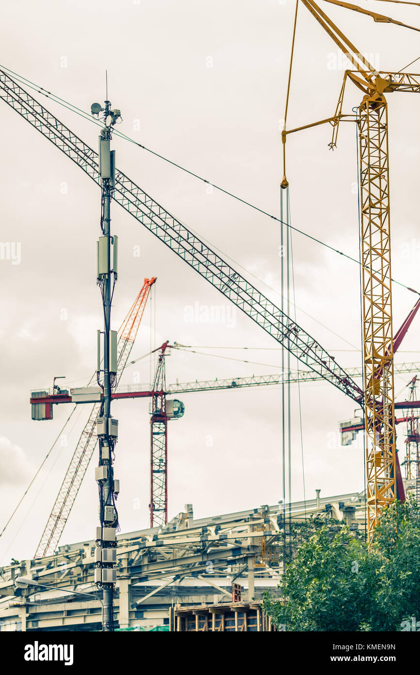 Crains on construction site of building Stock Photo - Alamy
