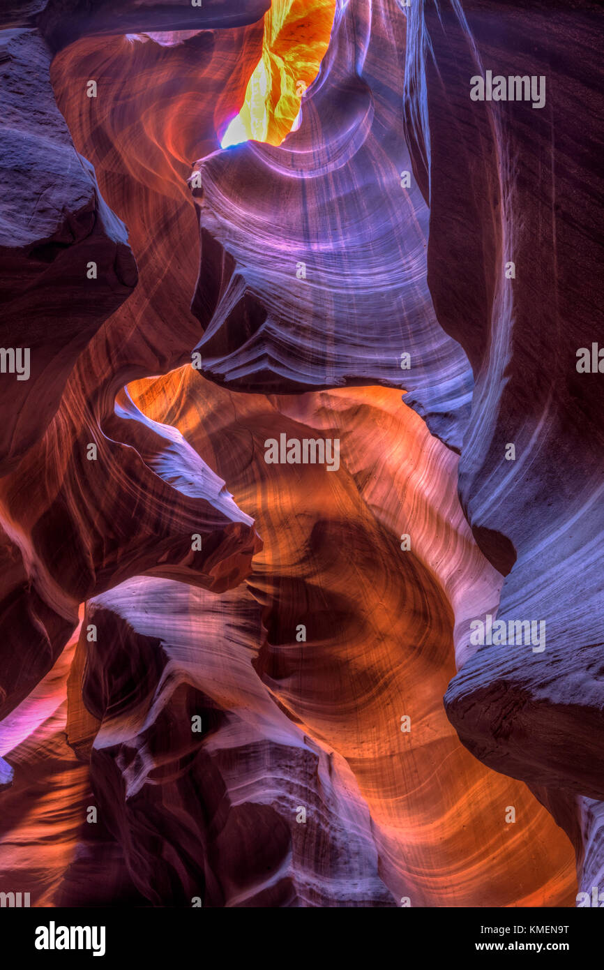 Twisting, striated red sandstone walls of AUpper Antelope Canyon lit ...