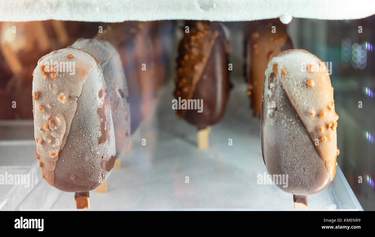 Selection of frozen milk chocolate icecream in the fridge at display at ...