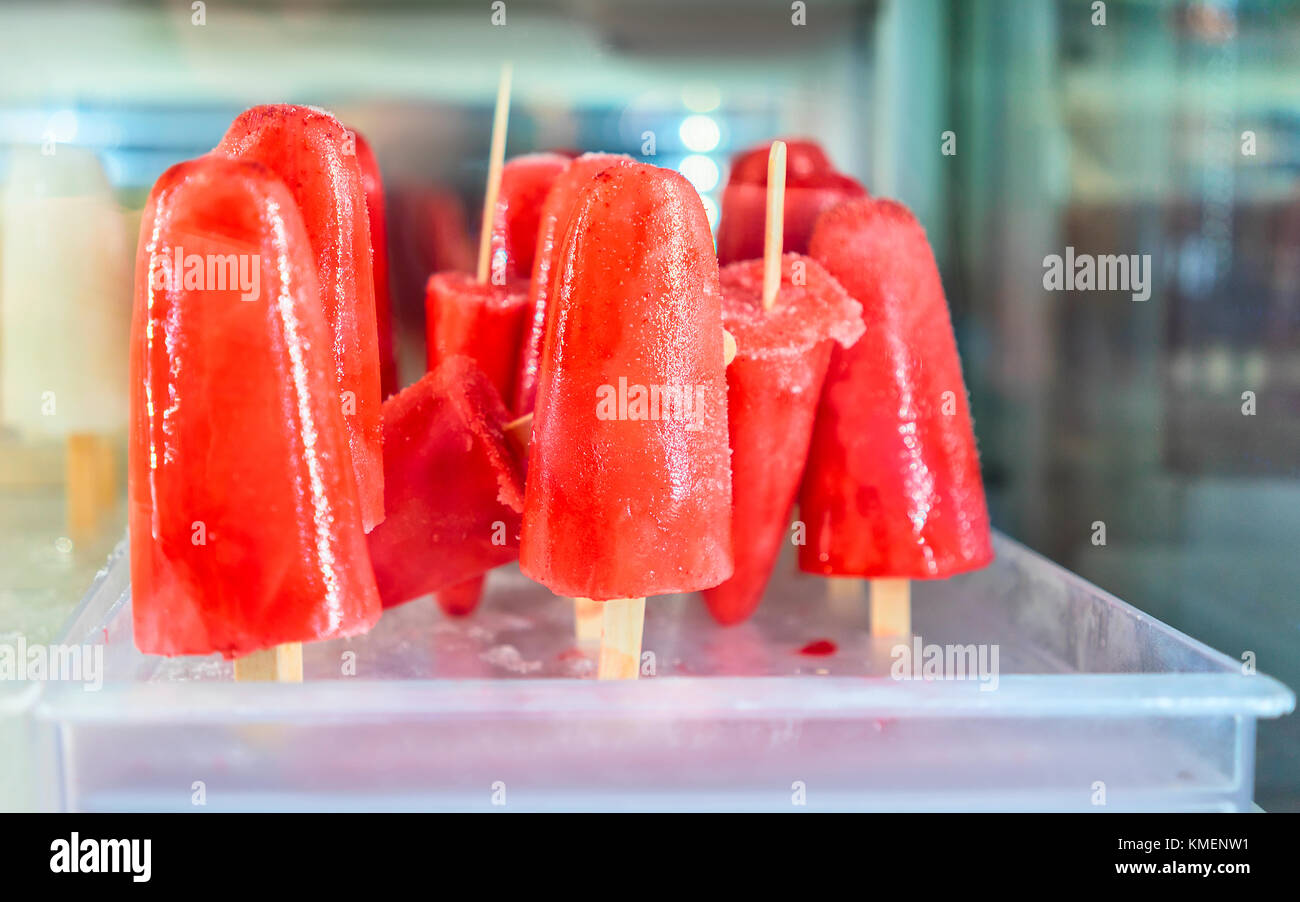 Selection of red frozen fruit sorbet icecream in the fridge on display ...