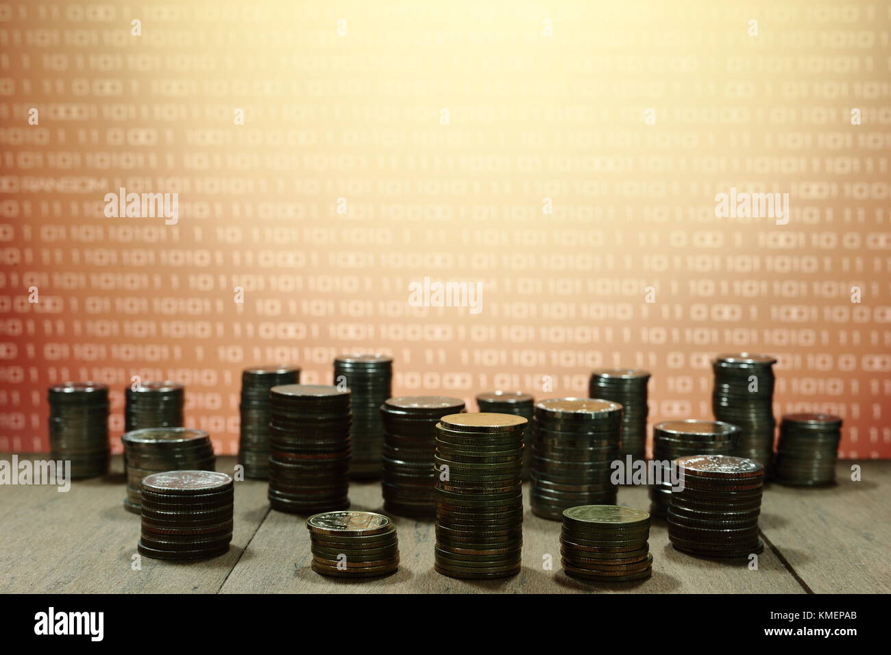 vintage digital economy coin pile stacked in to columns on wooden board ...