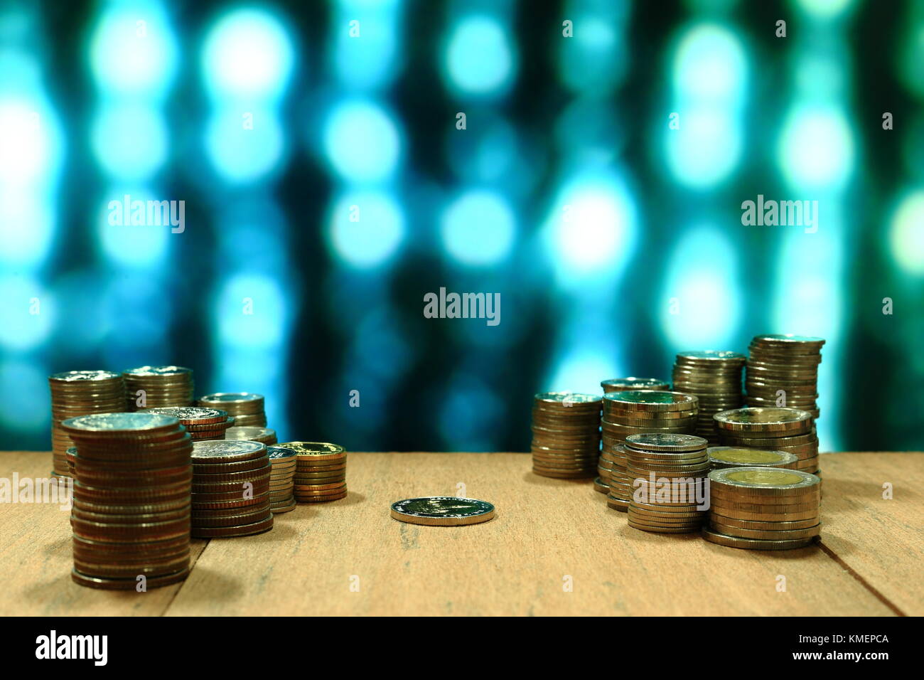 vintage digital economy coin pile stacked in to columns on wooden board ...