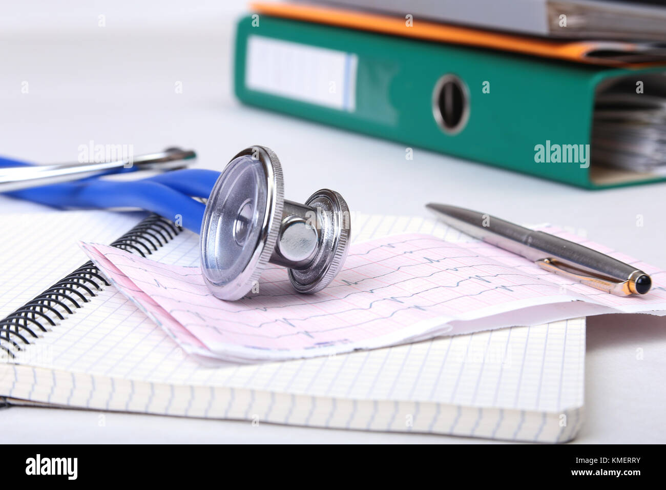 Folder file, stethoscope and RX prescription on the desk. blurred ...