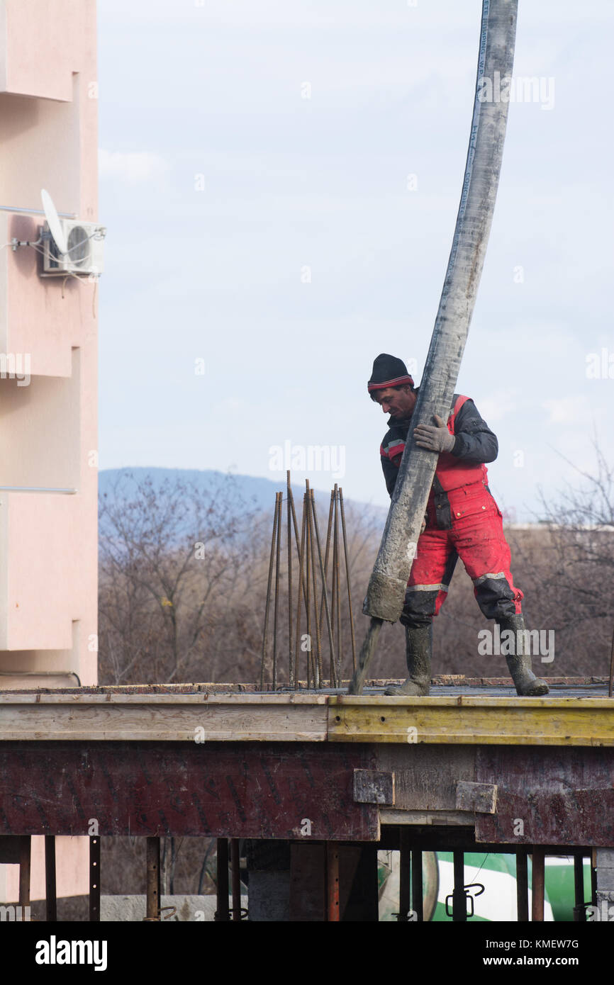 Bulgarian workers concrete a flat slab ceiling of the new house Stock ...