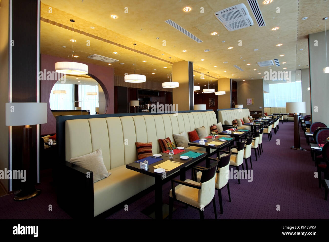 Long table at smart restaurant Stock Photo - Alamy