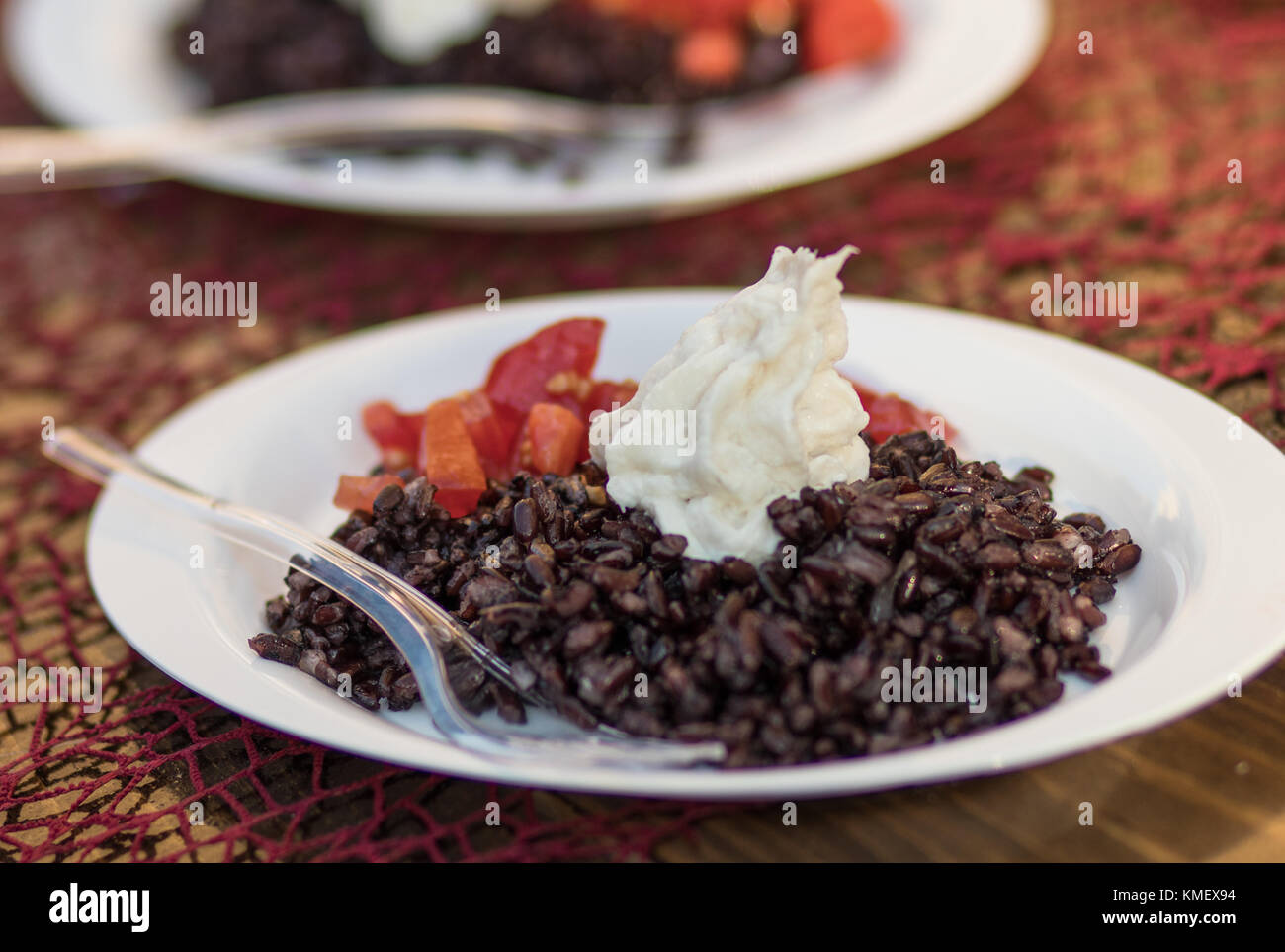 Black rice plate with tomato and ricotta cheese Stock Photo - Alamy