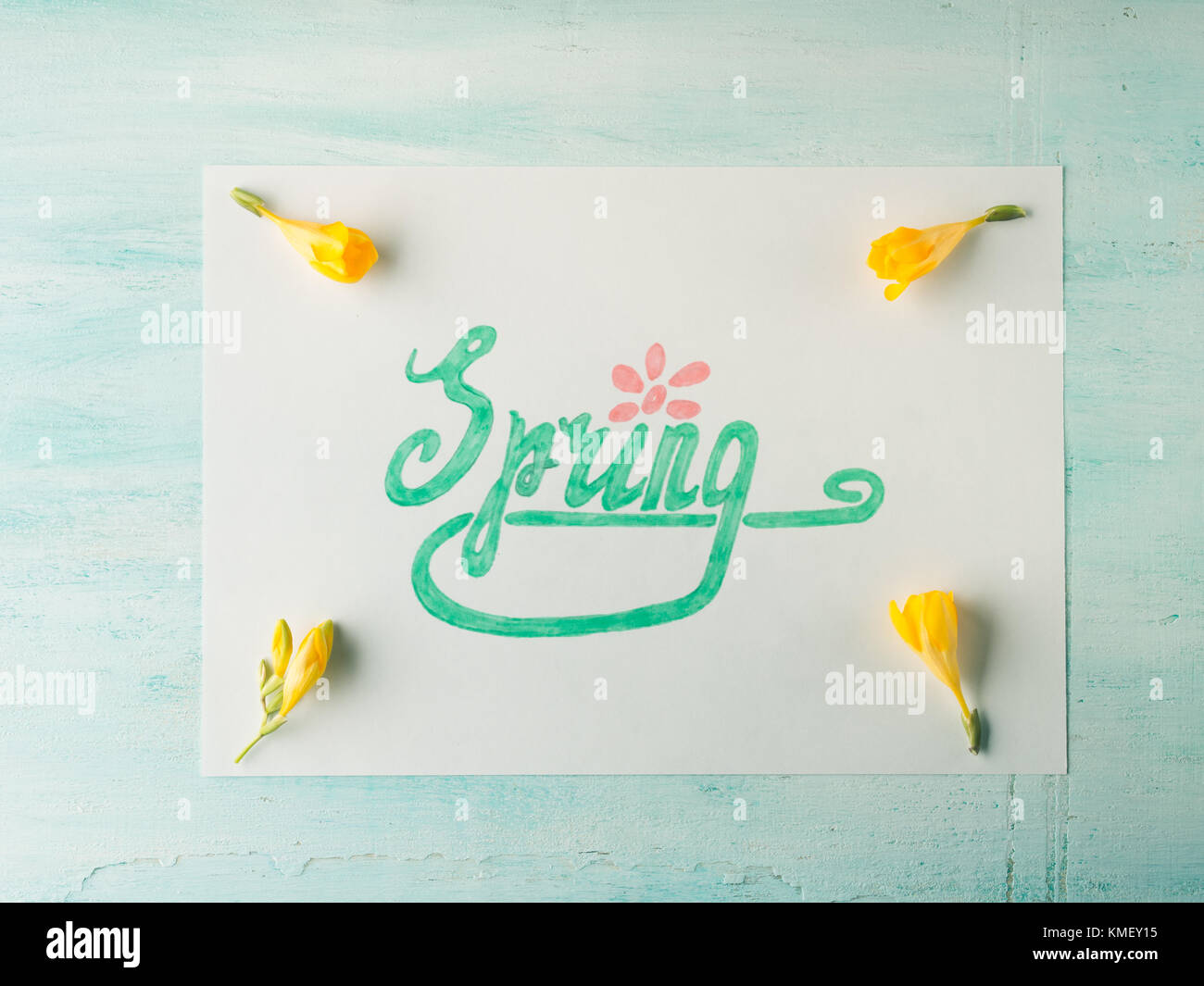 Spring word spelling by hand lettering and yellow flowers frame. Flat ...