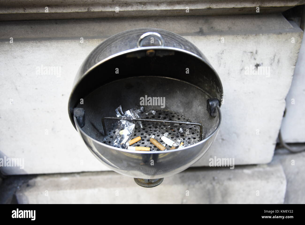 Sphere shaped ashtray on a wall outside a restaurant in London, England ...