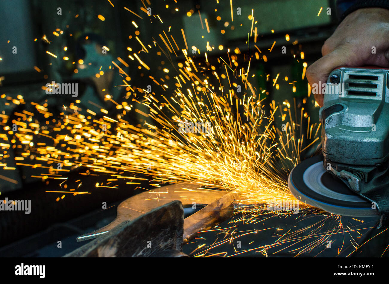 Industrial grinder showers sparks while working with metal Stock Photo ...