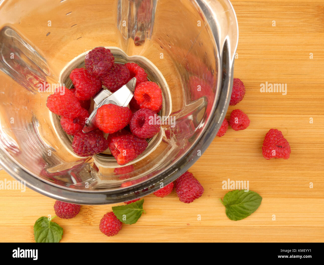 Raspberries in the blender on wooden plank Stock Photo - Alamy