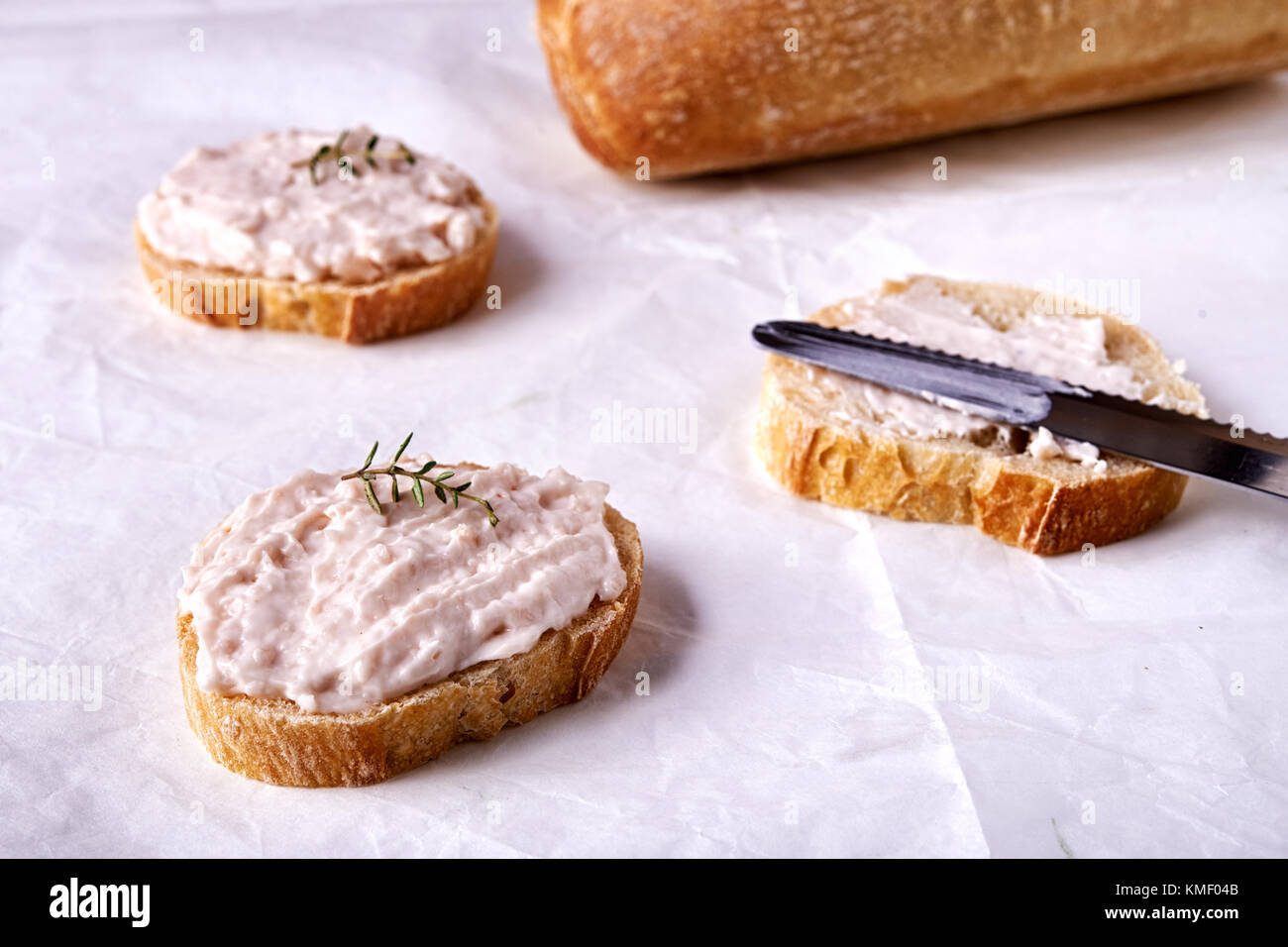 slices of bread with fish spread on white background Stock Photo - Alamy