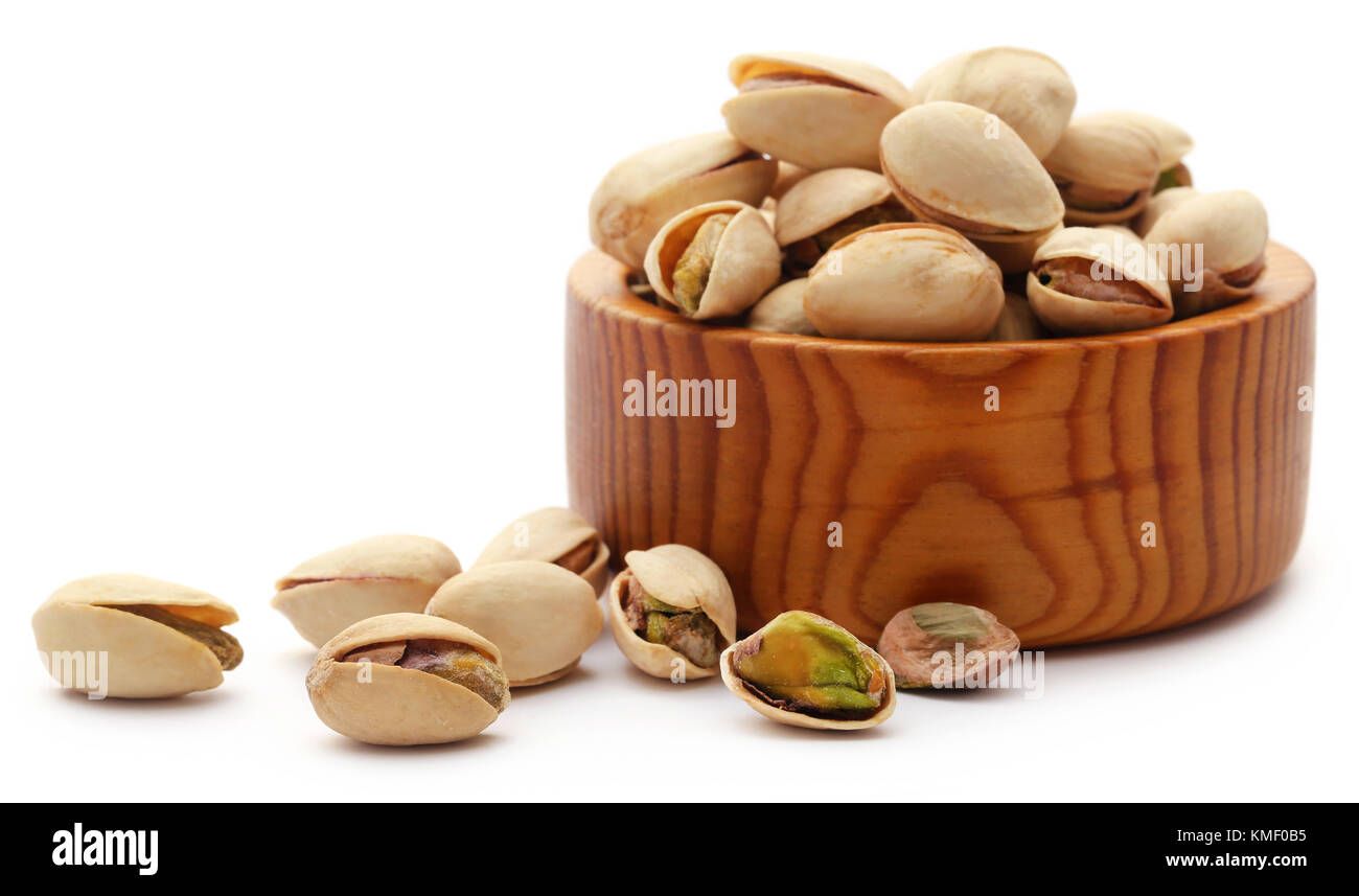 Closeup of some roasted pistachio in bowl over white background Stock ...