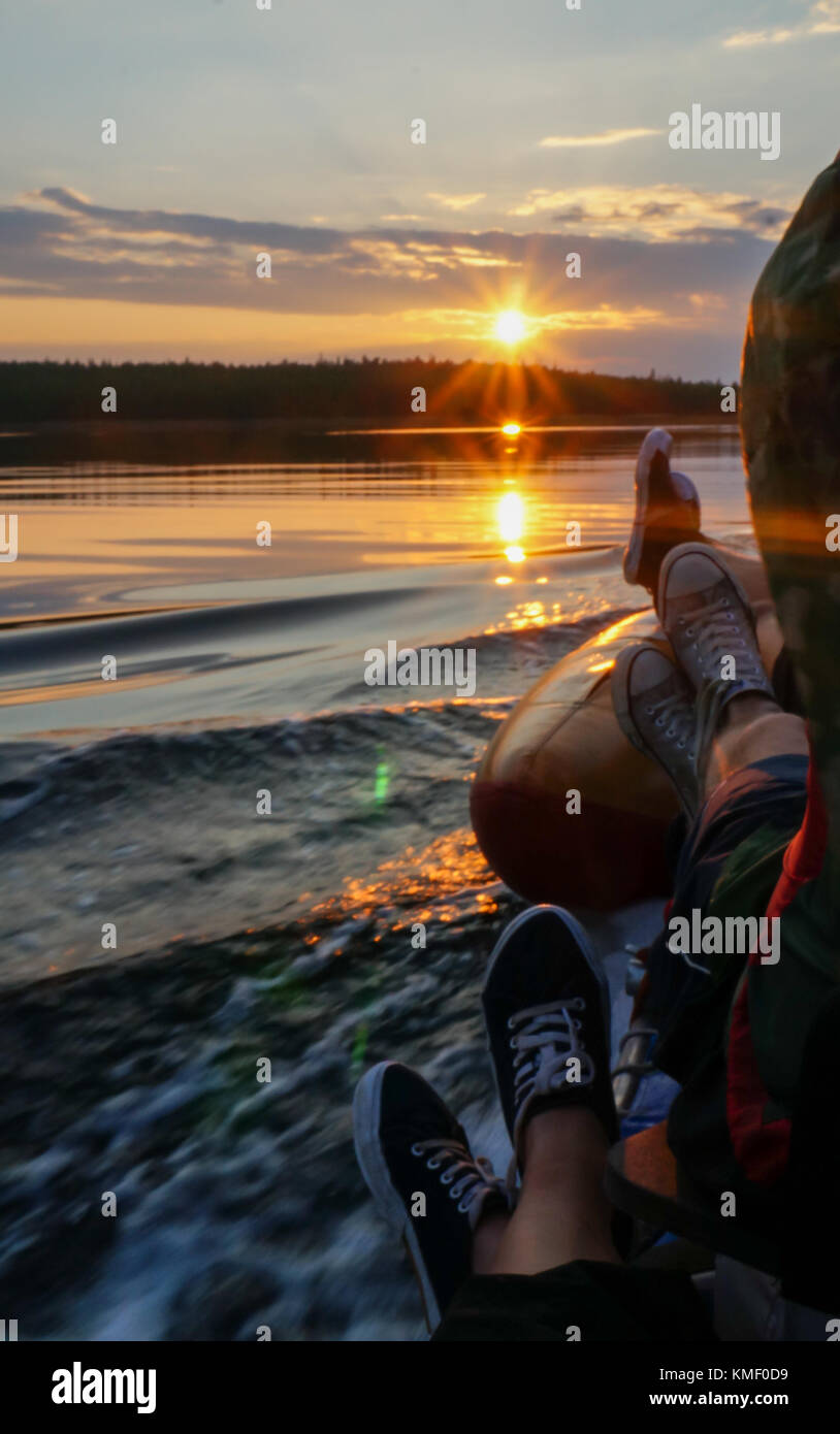 Boat on lake at sunset Stock Photo - Alamy