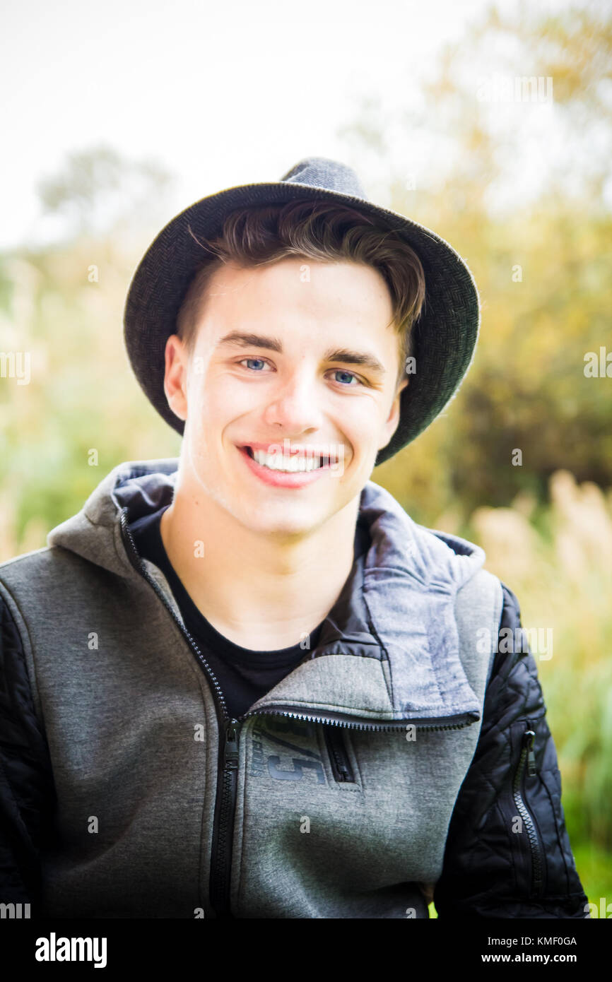 Portrait of young man smiling with nature background Stock Photo - Alamy