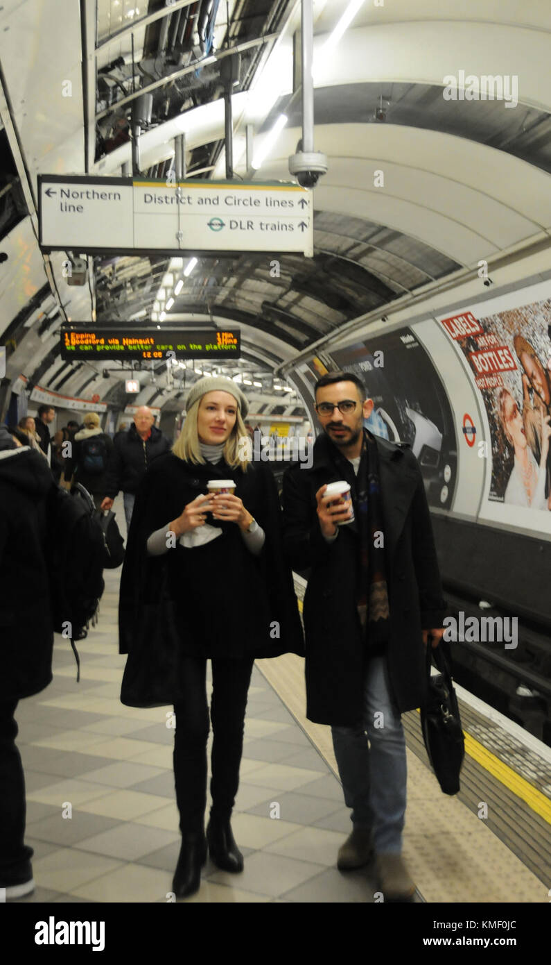 Time poor Commuters drinking coffee on the go, Central line, London ...
