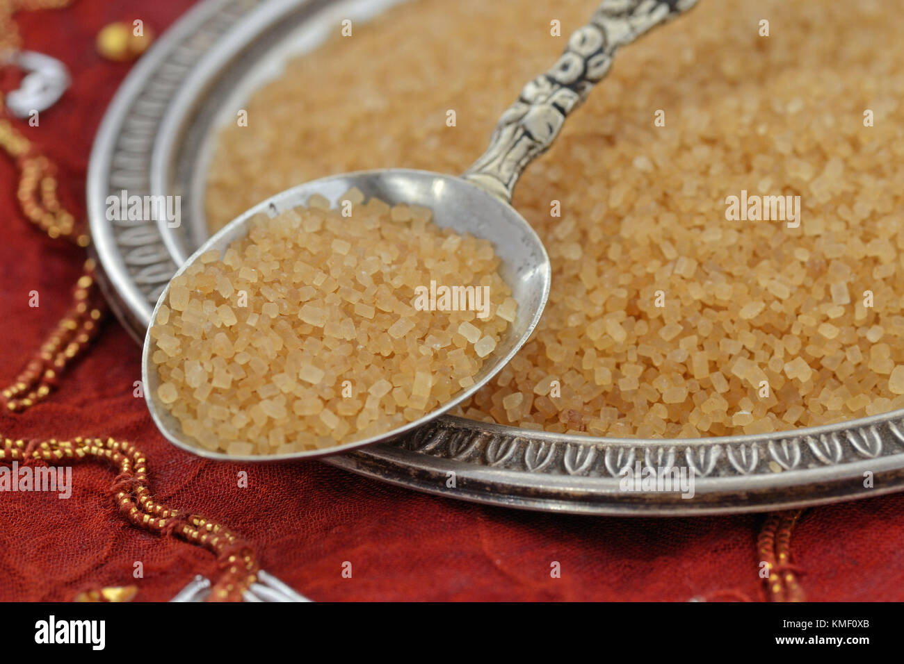 Brown sugar on spoon and plate Stock Photo - Alamy