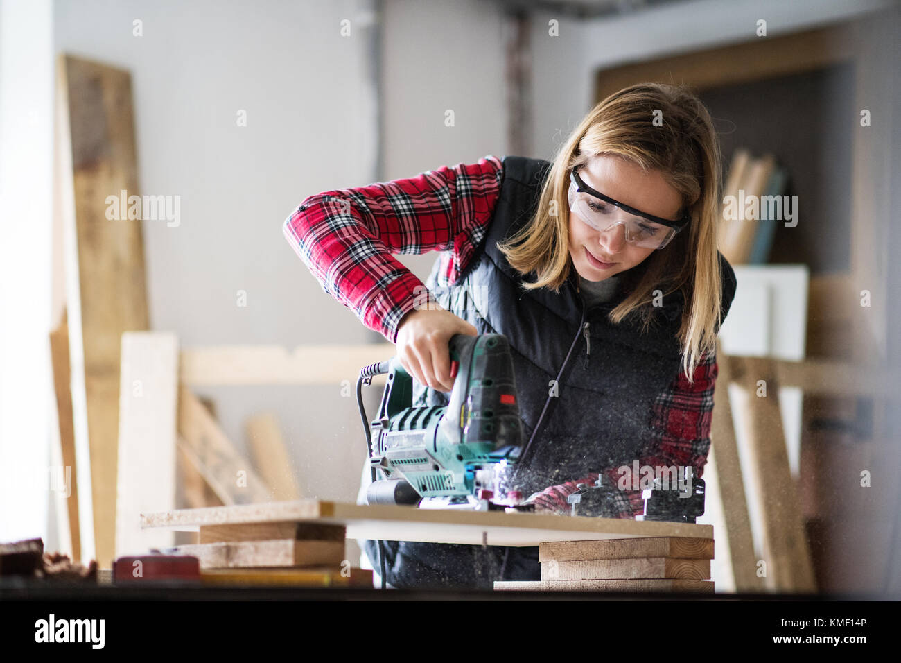 Young woman worker in the carpenter workroom Stock Photo - Alamy