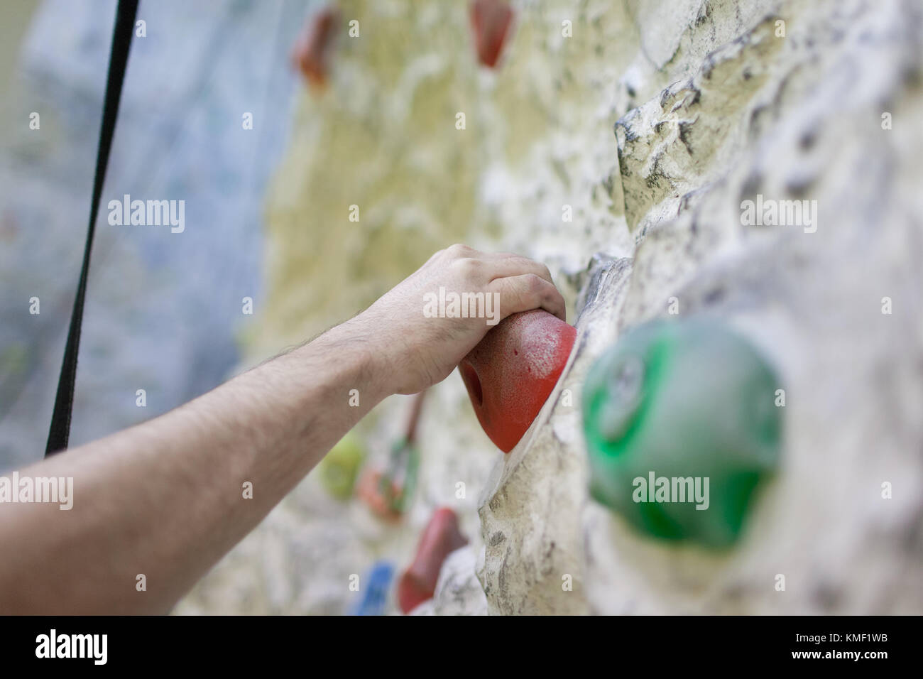 the man's hand climbing on an artificial wall Stock Photo - Alamy