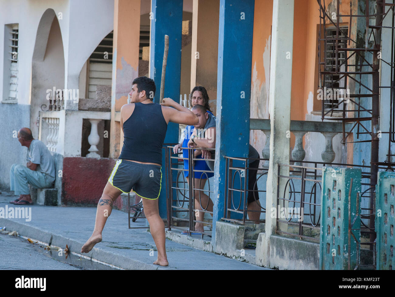 Cuban man playing baseball in the street Stock Photo - Alamy