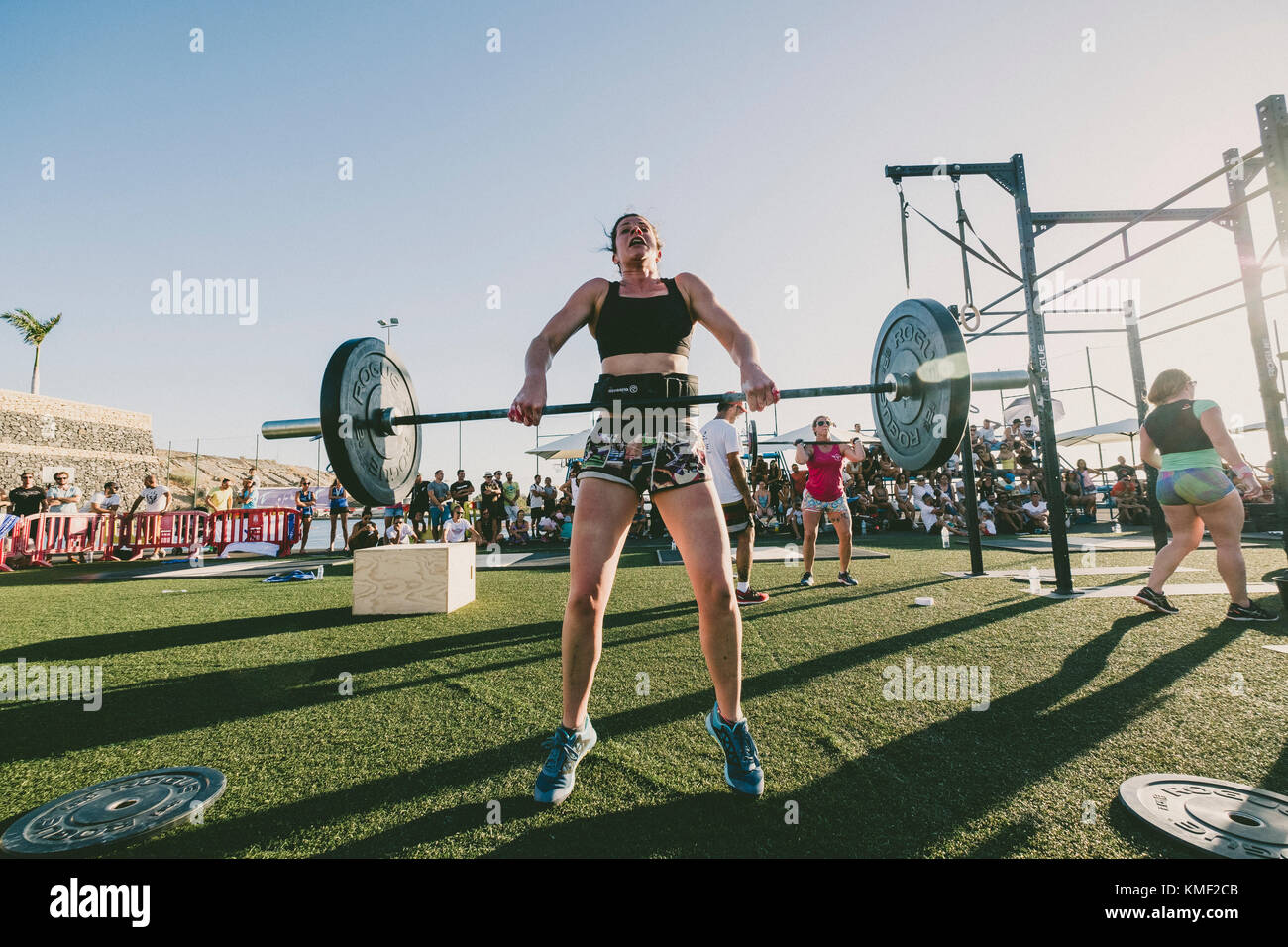 Front view of female athlete lifting weights during competition ...