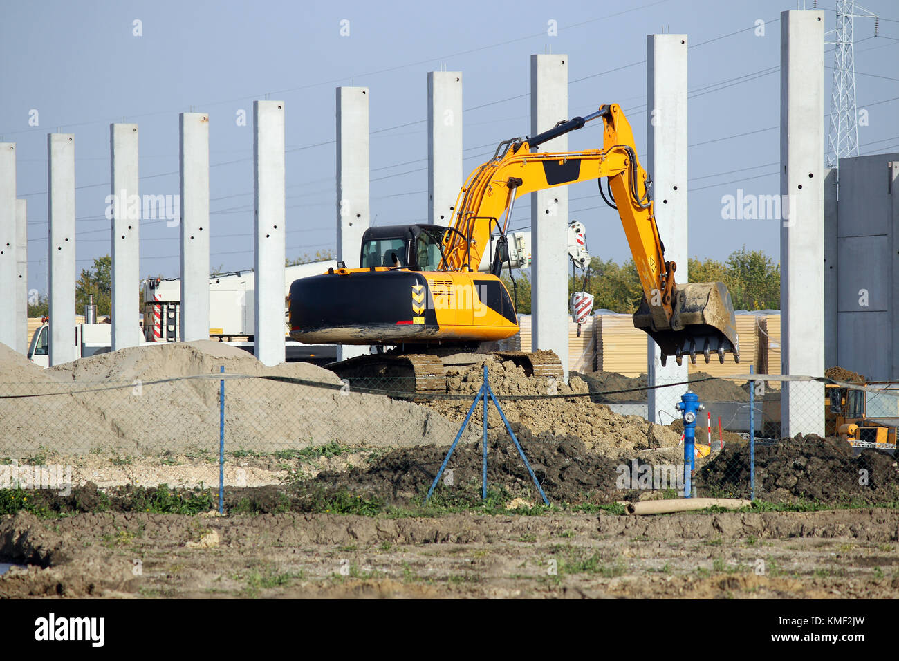 excavator working on new factory construction site Stock Photo - Alamy