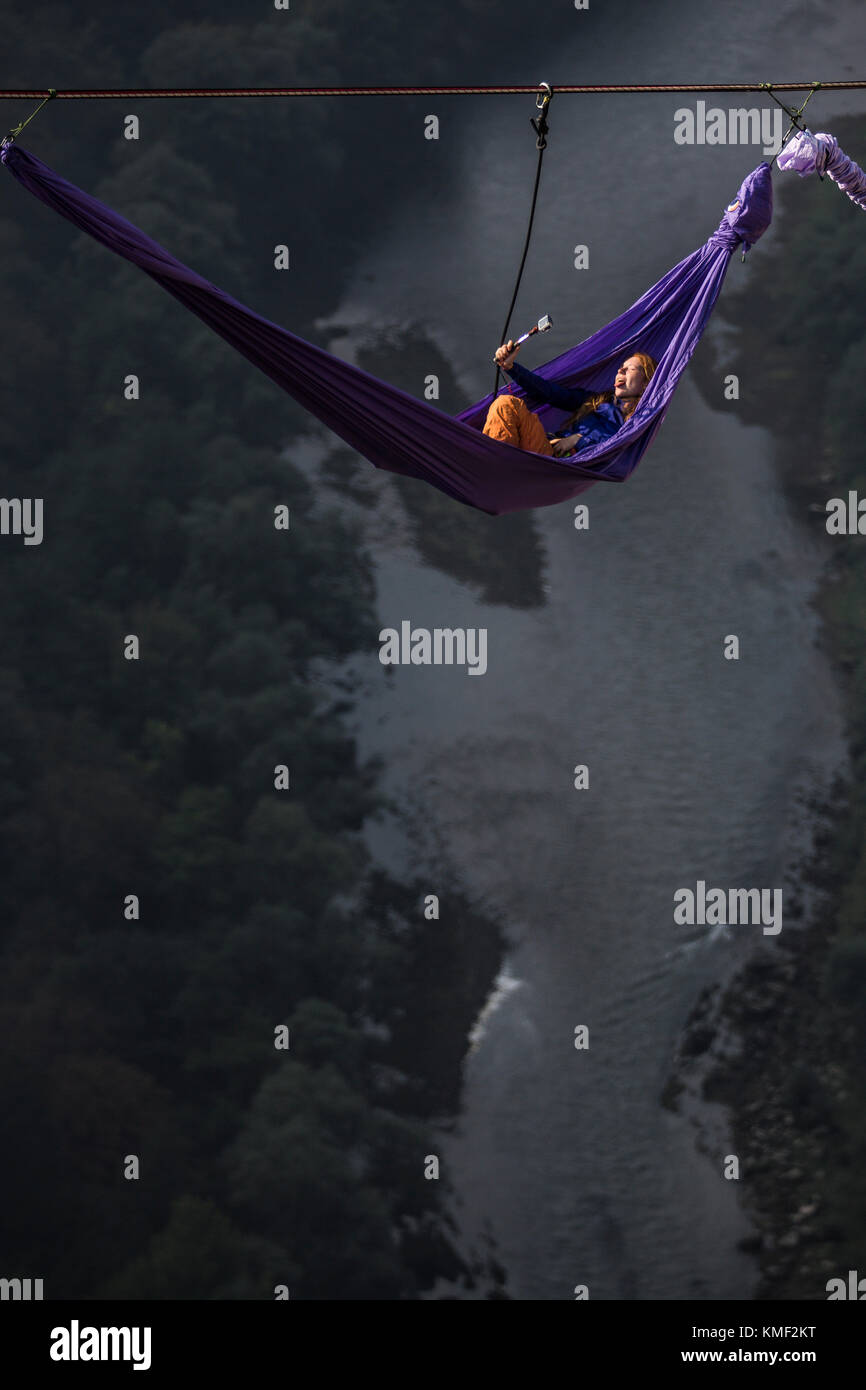 Side view of person lying in hammock and hanging on high line,Tijesno ...