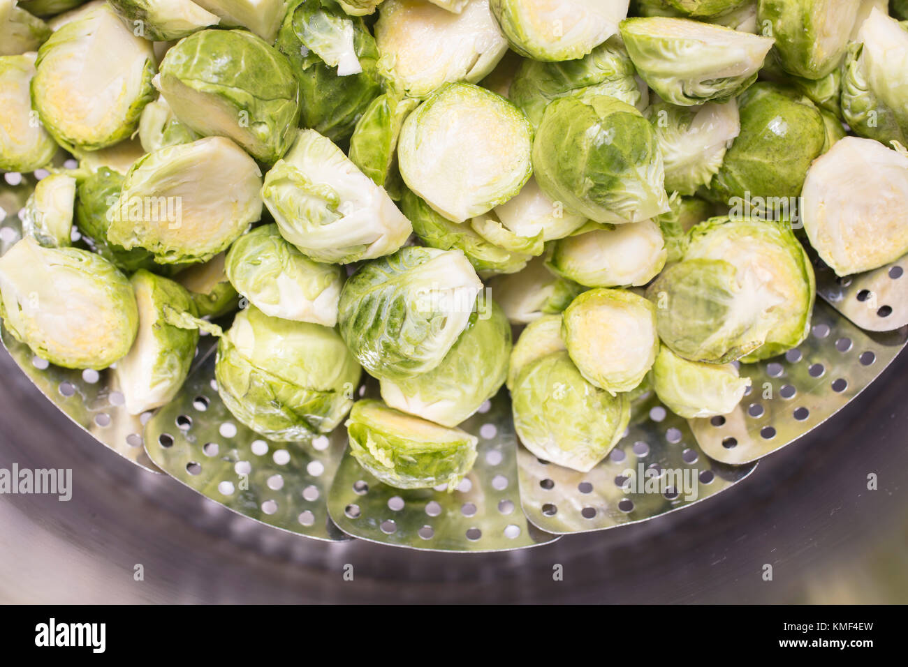 Brussel Sprouts in a steaming rack inside of a pot for cooking Stock ...