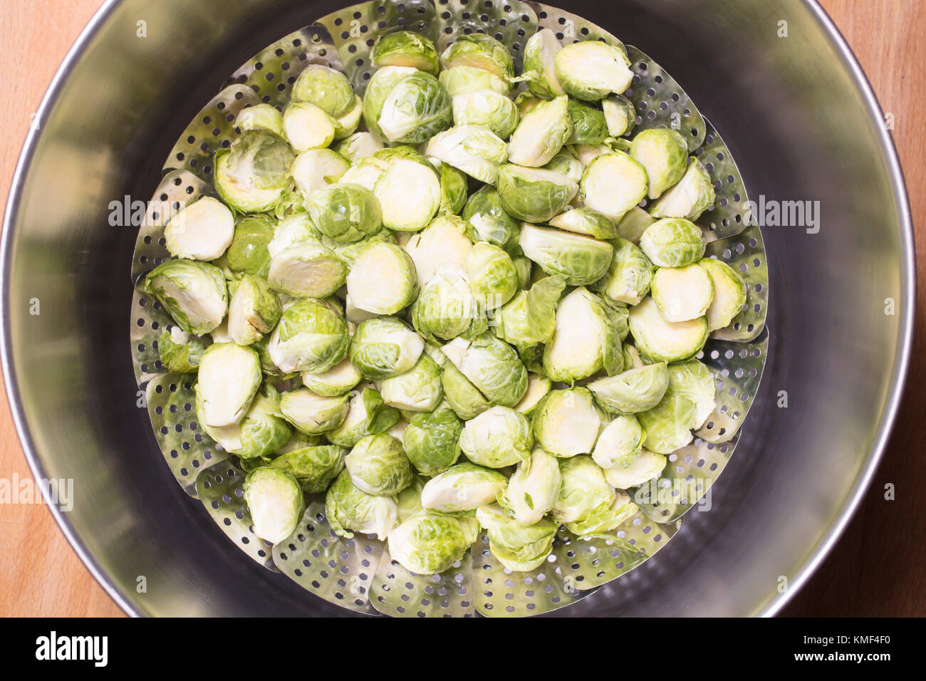 Brussel Sprouts in a steaming rack inside of a pot for cooking Stock ...