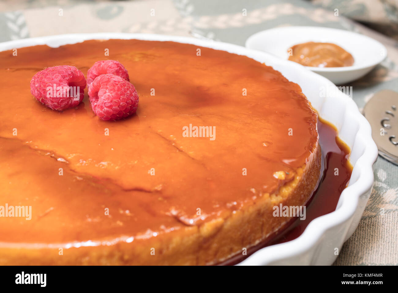 Creamy Flan dessert served with raspberries and dulce de leche served ...